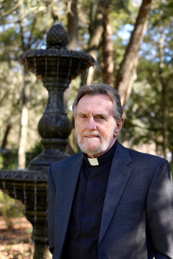 Going the distance: Msgr. Carter crosses the finish to the gold - The ...